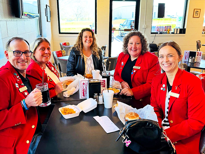 The red jackets brigade enjoying what might be the most authentic American dining experience left—conversation, comfort food, and zero pretension.