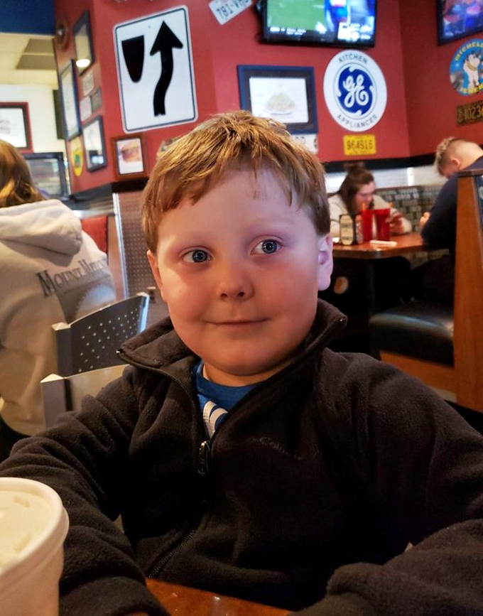 The restaurant welcomes diners of all ages, where vintage signs and red walls create the perfect backdrop for burger-induced happiness.