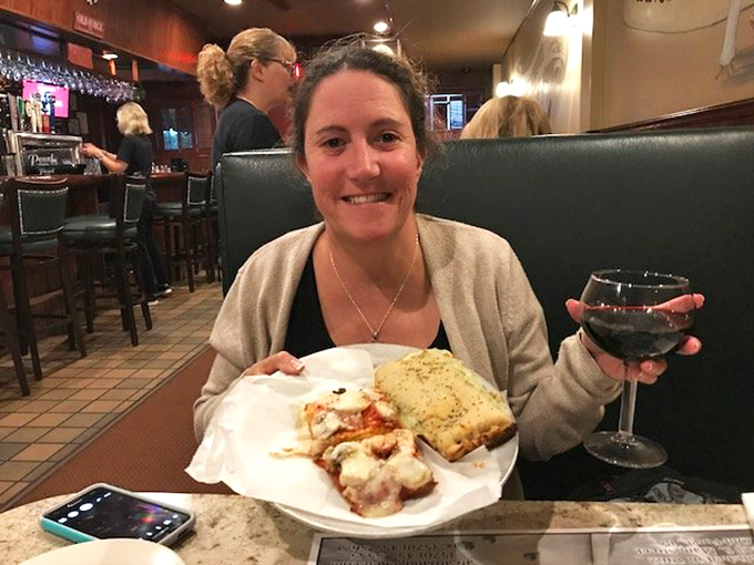 The true measure of a great restaurant: the look of pure joy on a diner's face. That plate of Italian goodness is about to create a memory.