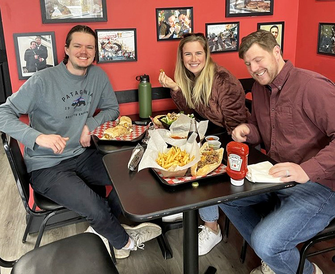 Happy diners experiencing the universal language of great food. Their expressions say what words cannot—they've found the good stuff.