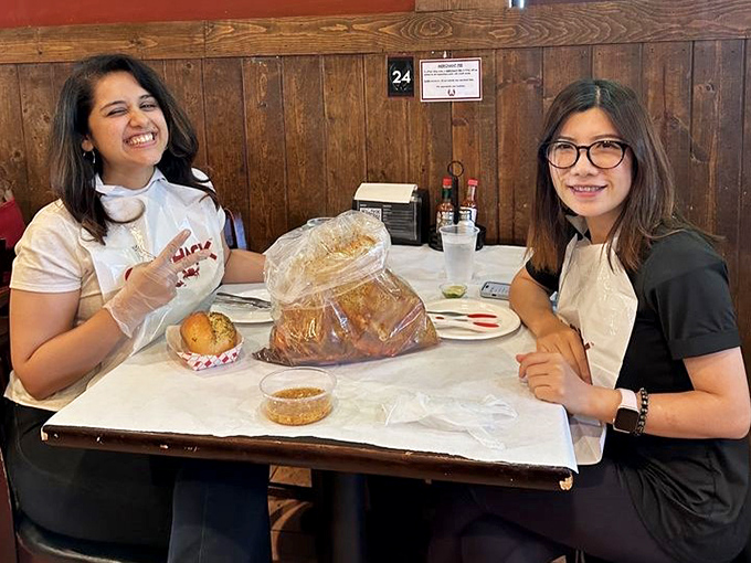 The true Claw Shack experience: plastic bibs, plastic gloves, and smiles that say "We've discovered something wonderful here."