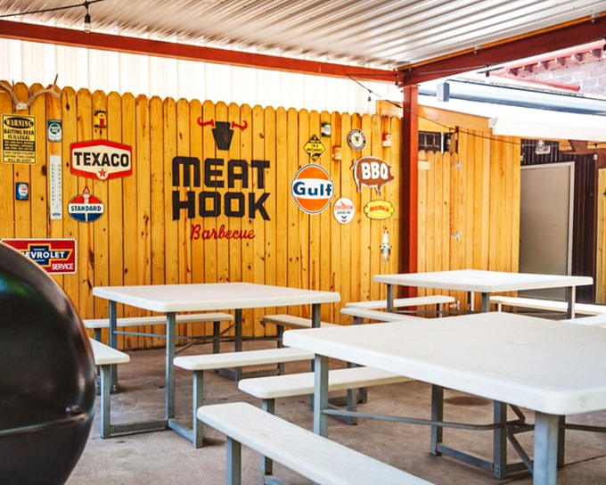 Vintage signs and wooden walls create the perfect backdrop for serious barbecue business. No distractions, just dedication to the craft.
