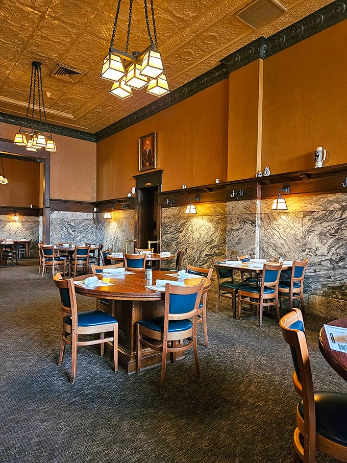 Marble walls meet ornate ceilings in this dining room where every table feels like the best seat in the house.