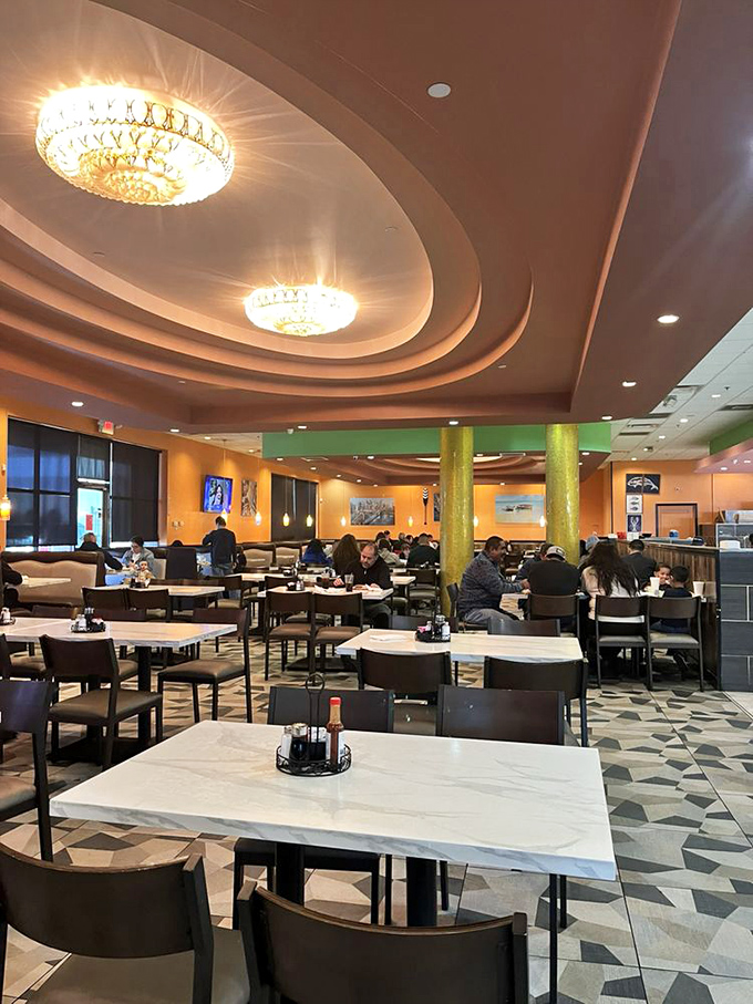 The dining area hums with the satisfied murmurs of patrons plotting their next buffet strategy. Elegant chandeliers oversee the feast.