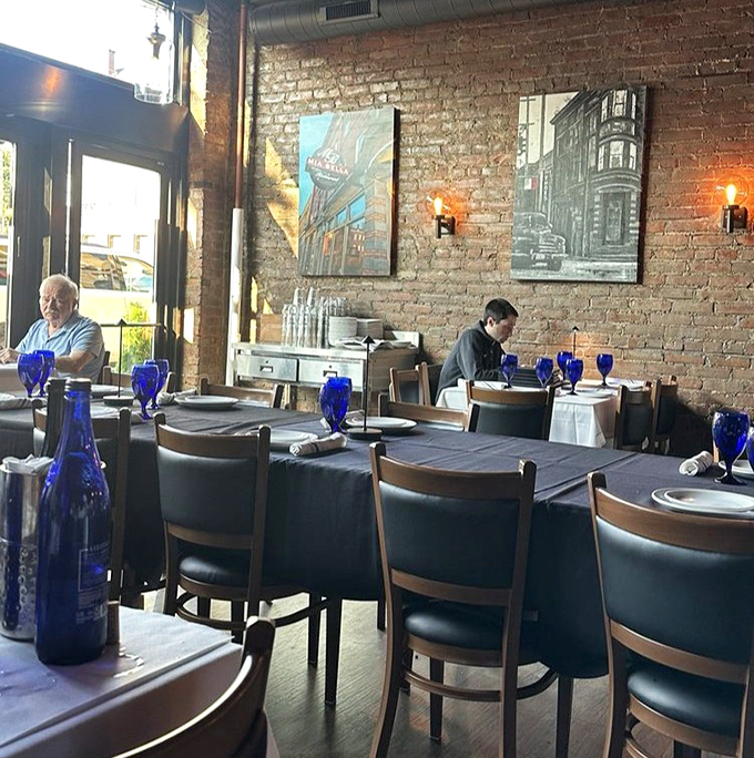 Exposed brick walls tell stories of Cleveland's past while blue bottles stand sentinel on white tablecloths, creating an ambiance that's both historic and thoroughly modern. 