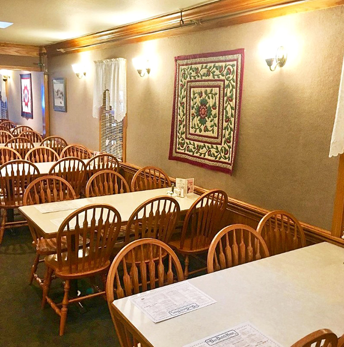 Quilted wall hangings and wooden furniture create an atmosphere where time slows down for proper dining.