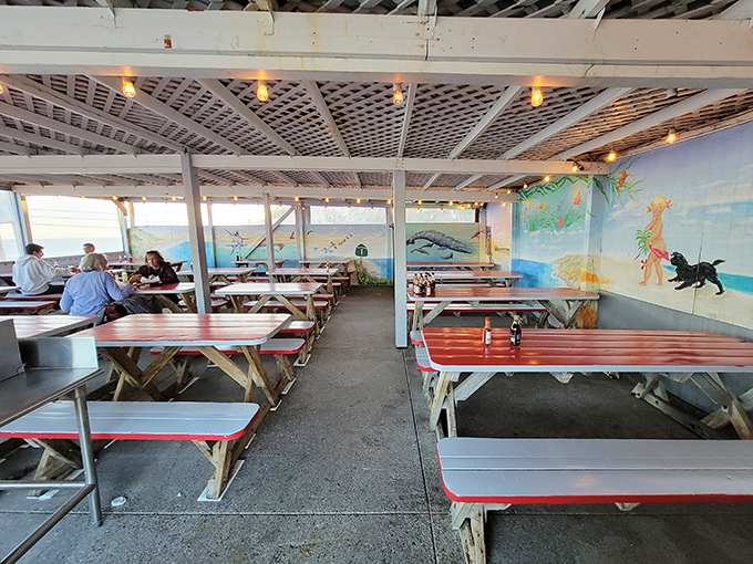 The dining area's coastal murals and picnic tables create a vibe that's part summer camp, part seafood paradise. No white tablecloths needed when the food speaks this loudly.