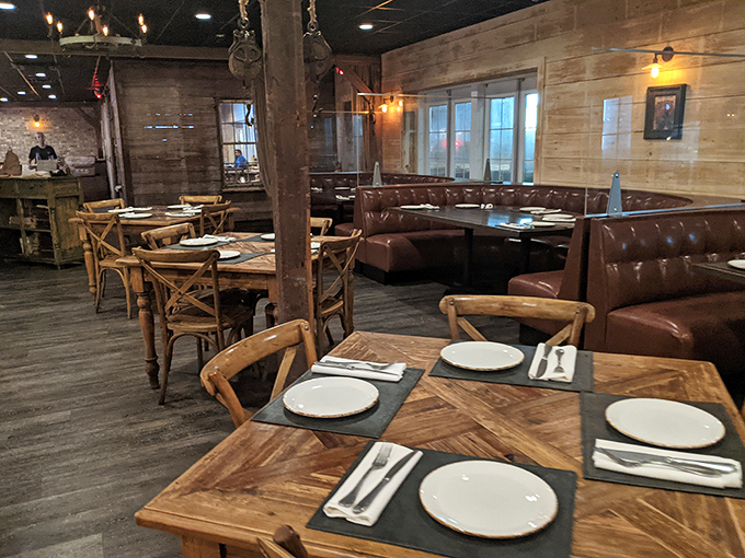 Tables set with care and anticipation. The leather banquettes and wooden chairs invite you to settle in for what might be the highlight of your week.