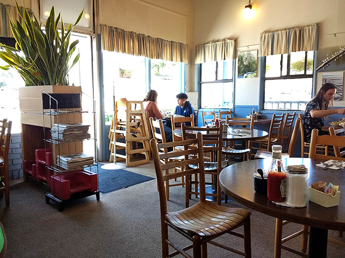 Morning light streams through windows, illuminating wooden chairs that have supported countless happy breakfasters through the years.