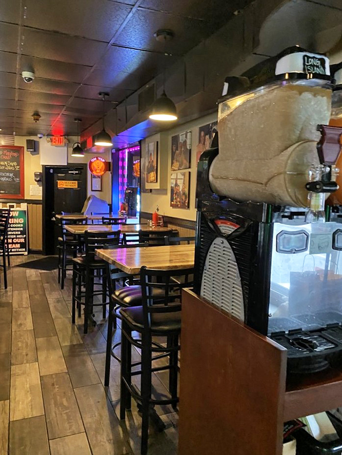 Where conversations flow as smoothly as the drinks. The bar area's warm lighting and wooden accents create the perfect neighborhood hangout vibe.