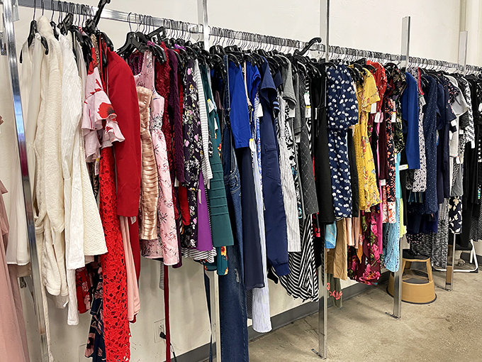 The dress rack: a textile rainbow where vintage florals, power suits, and cocktail attire create a fashion timeline spanning decades of style evolution.