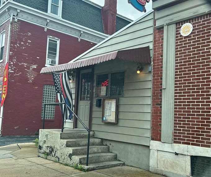 The entrance beckons with its simple charm and "OPEN" sign glowing like a lighthouse for the breakfast-starved traveler.