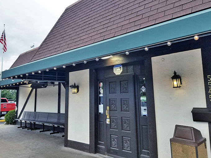 The entrance beckons with its carved wooden door and lantern lighting. Like the wardrobe to Narnia, but instead of snow, you'll find sauce and cheese.