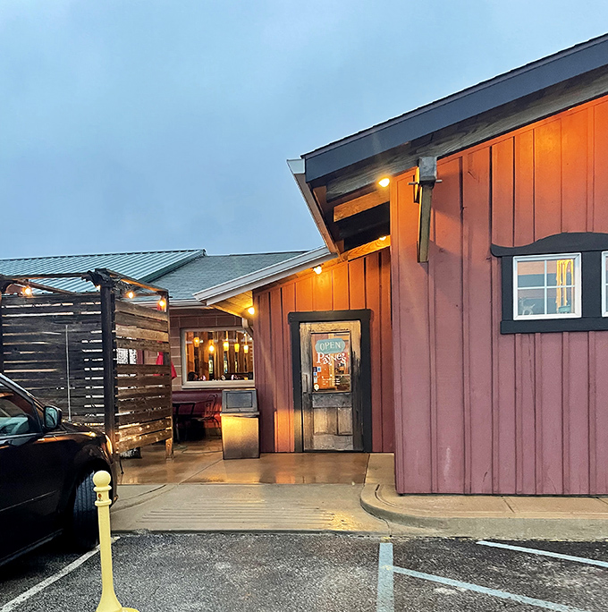 As dusk falls, the warm glow of Payne's entrance beckons like a lighthouse guiding hungry travelers to safe, delicious harbor.