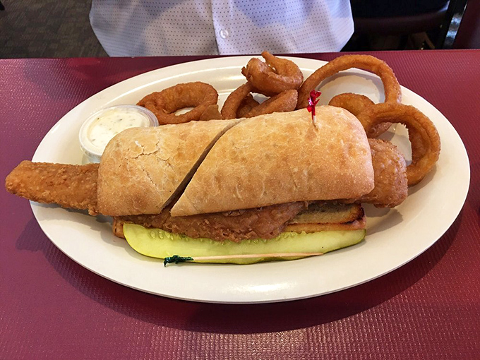 A fish sandwich that makes you wonder why you ever settled for fast food versions, served with onion rings that deserve their own fan club.
