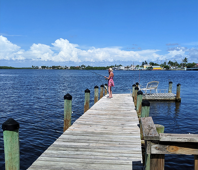 A lone angler casts hopes and dreams from a weathered dock. In Matlacha, fishing isn't just a hobby&mdash;it's a meditation. 
