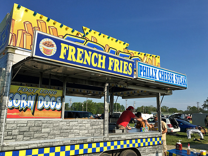 The siren call of fair food! This classic stand promises the holy trinity of flea market sustenance: corn dogs, fries, and cheesesteaks.