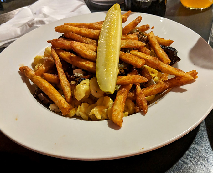 Crispy fries atop creamy mac and cheese with that pickle standing guard like a delicious sentinel. Carb-on-carb action at its finest.