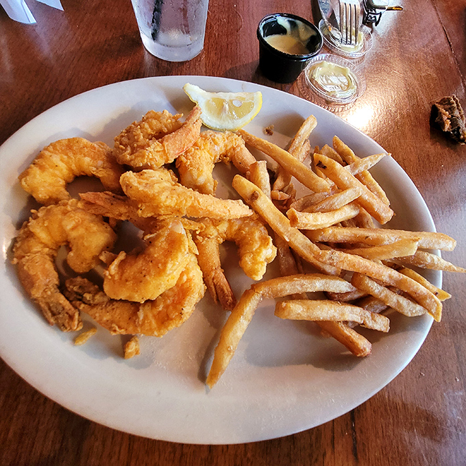 These golden-battered shrimp and hand-cut fries aren't just seafood &ndash; they're edible sunshine that captures the essence of coastal Florida on a plate.