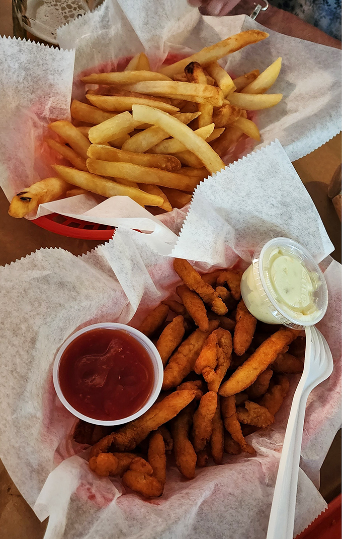 The ultimate seafood sidekicks—golden fries and perfectly fried seafood morsels, proving that sometimes the simplest pleasures are the most satisfying.