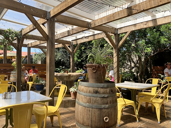 Garden seating that makes you want to linger all day. Those yellow chairs practically whisper, "Call the office, you're working remotely today."