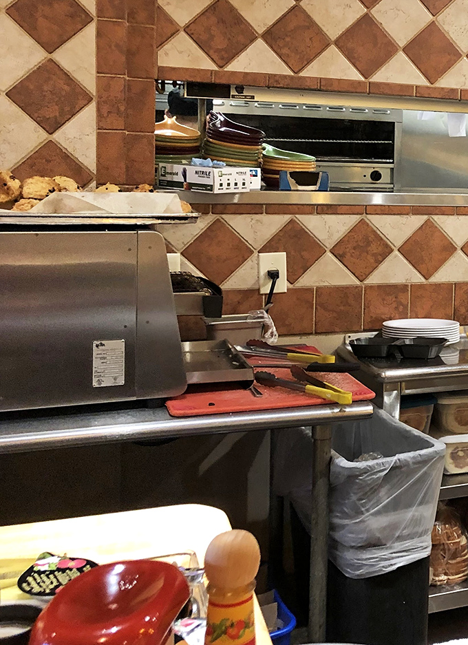 Where breakfast dreams come true – behind the scenes in Skillets' kitchen, where copper pans hang like medals of honor on tiled walls.