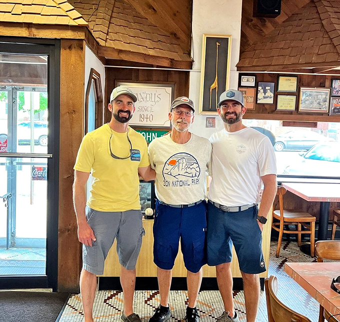 Three generations of cheesesteak devotion standing by the "Since 1940" sign. In Pennsylvania, sandwich-making is a family tradition worth preserving.