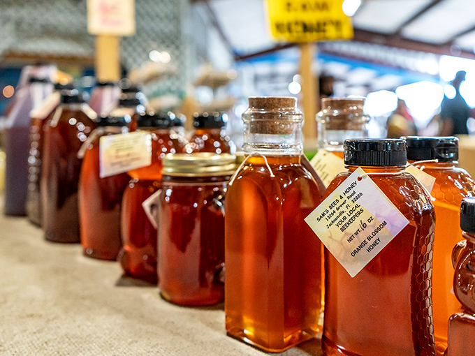 Liquid gold in glass bottles! Local honey varieties line up like amber jewels, each promising distinctive flavors from Florida's diverse flora.