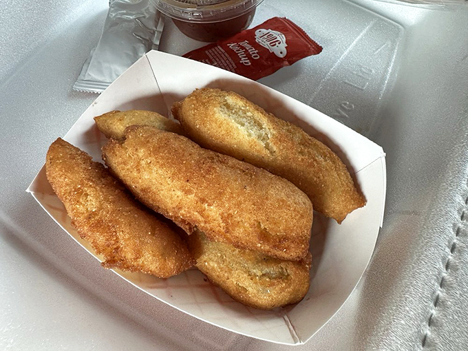 Hush puppies that crunch like they're keeping delicious secrets. These golden orbs of cornmeal joy are what other side dishes aspire to be.