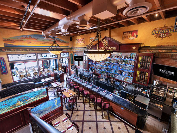 The bar area offers a bird's-eye view of mixology magic, with enough bottles to make you wonder if they've somehow connected a pipeline to every distillery in America.