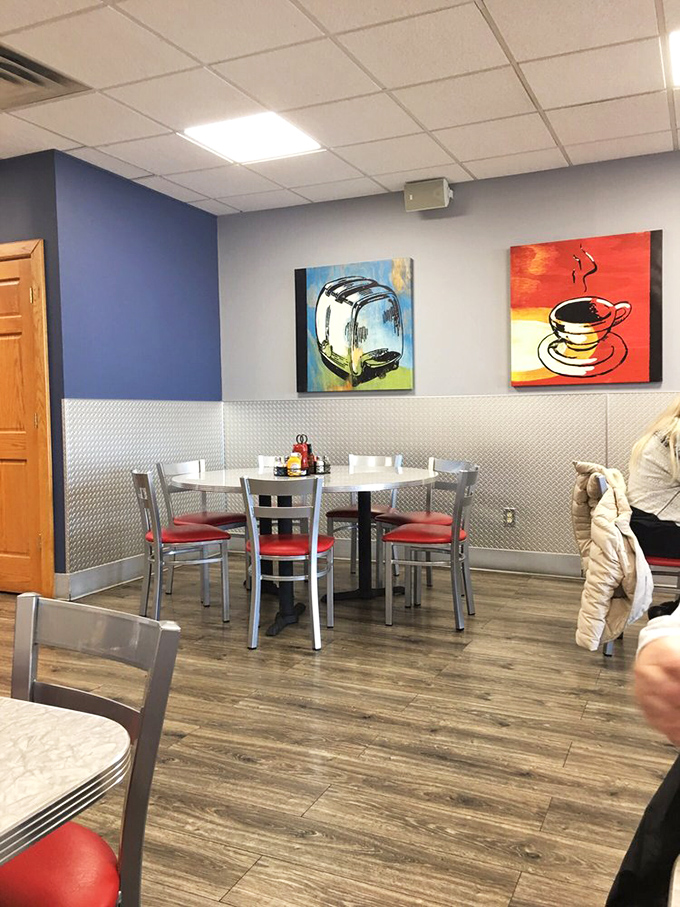 Kitchen art that actually makes sense in a restaurant. The toaster and coffee cup paintings aren't pretentious—they're a playful nod to breakfast essentials.