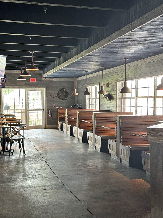 The dining room's rustic elegance whispers "stay awhile" with its wooden booths and pendant lighting creating the perfect seafood sanctuary.
