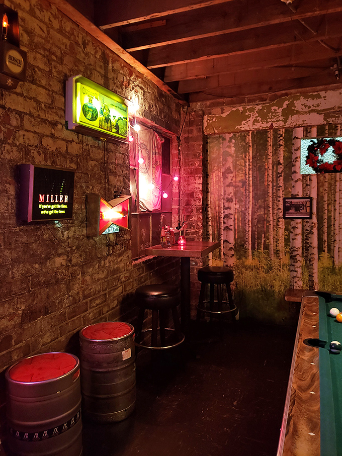 Neon beer signs cast a warm glow over exposed brick walls, creating that rare atmosphere where strangers become friends over shared chicken stories.