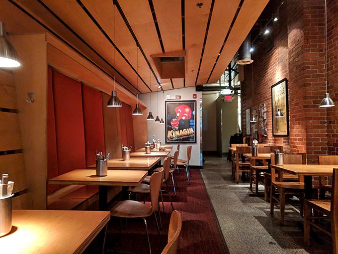 The dining room feels like the apartment of that friend who somehow always has better taste than you, with warm wood tones and exposed brick.