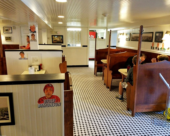 Church-like wooden booths create dining sanctuaries where generations have worshipped at the altar of comfort food. The caricatures are the saints of Scranton.