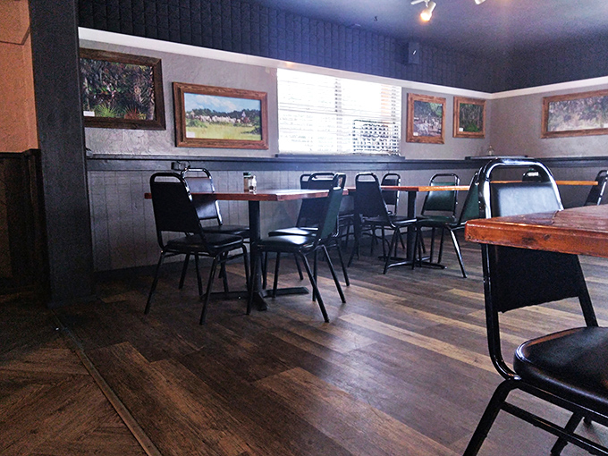 Local landscape paintings adorn walls where countless conversations have unfolded. This dining room feels like it has stories to tell.