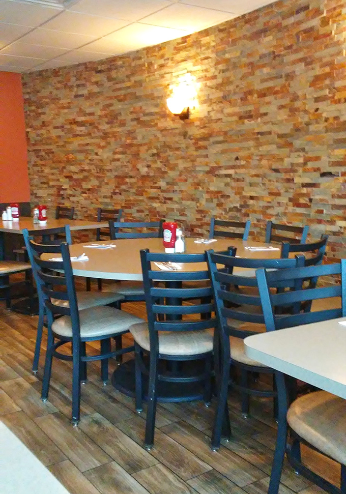 Stone accent walls and blue chairs create the perfect backdrop for the daily theater of diner life, where every table tells a different story.