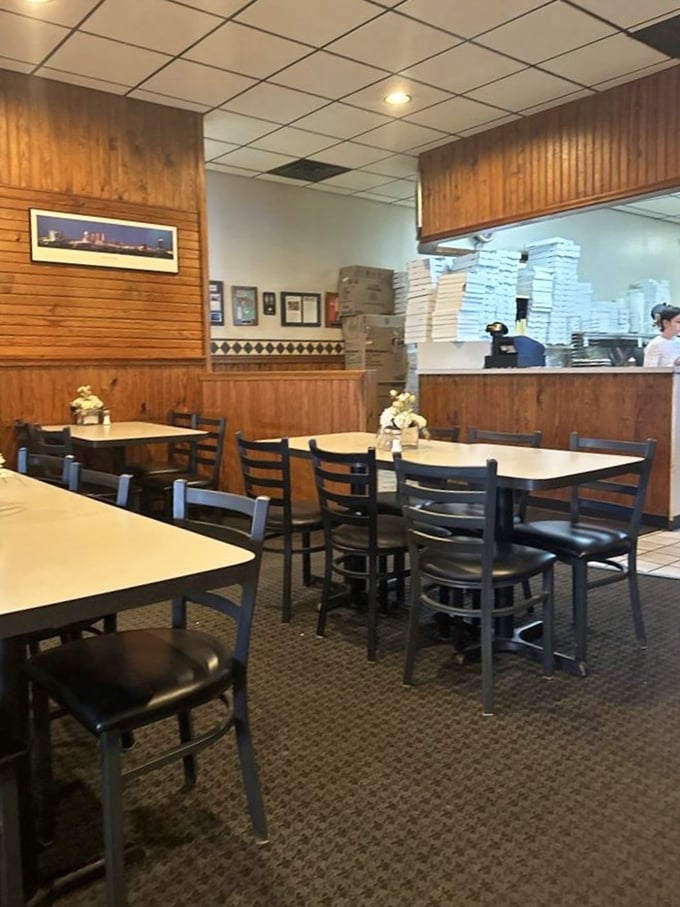 A glimpse into the kitchen reveals stacks of pizza boxes standing ready for duty&mdash;soldiers in the noble war against hunger.