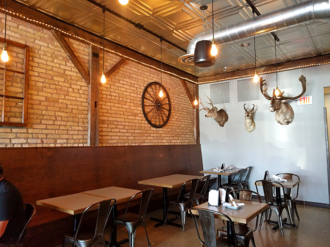 Rustic meets refined with wagon wheel accents and mounted trophies watching over diners like guardians of good taste.