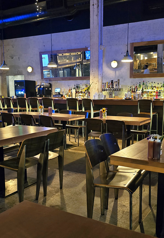 Industrial chic meets barbecue comfort &ndash; concrete floors and string lights creating the perfect backdrop for the meat sweats you're about to enjoy.