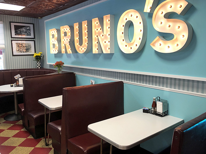 The retro-cool BRUNO'S sign illuminates a dining room where comfort reigns supreme. Those burgundy booths have heard decades of local gossip and laughter.