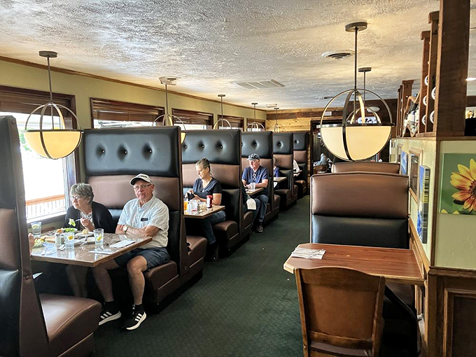 The dining room hums with conversation and clinking silverware. These booths have heard decades of local stories, celebrations, and everyday moments.