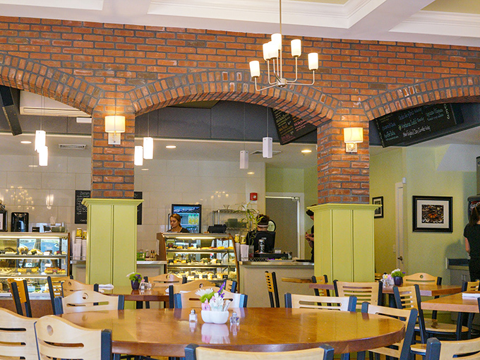 Exposed brick arches frame the bustling caf&eacute; area, where the serious business of enjoying good food happens beneath warm lighting.