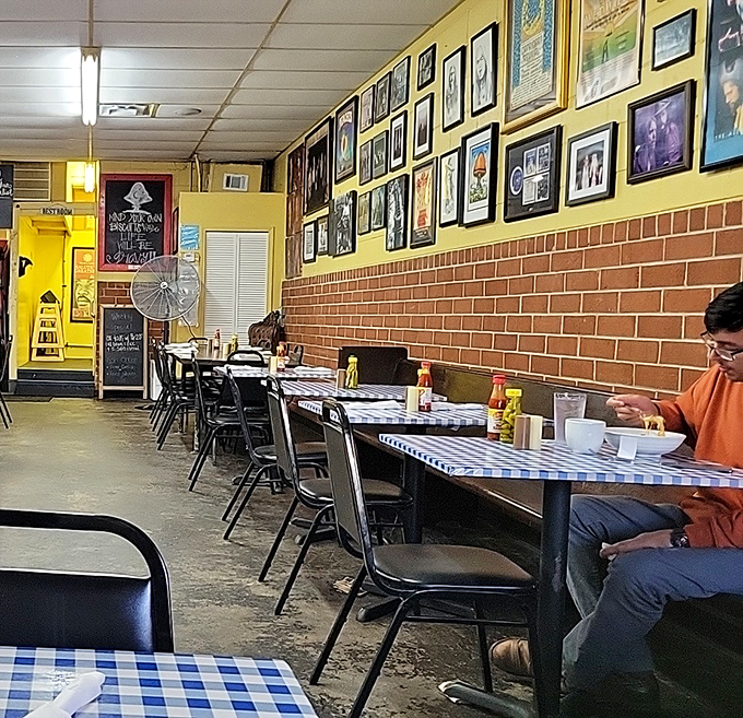 9. interior aSimple tables against yellow walls where strangers become neighbors and calories don't count because they're consumed in good company.nother angle