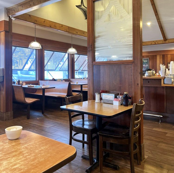 Wooden booths where breakfast dreams come true. The dividers create little sanctuaries for intimate conversations over pancakes and coffee.