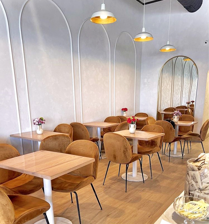 Where European café culture meets Midwest hospitality. The arched alcoves and golden chairs create intimate spaces for both conversation and contemplation.