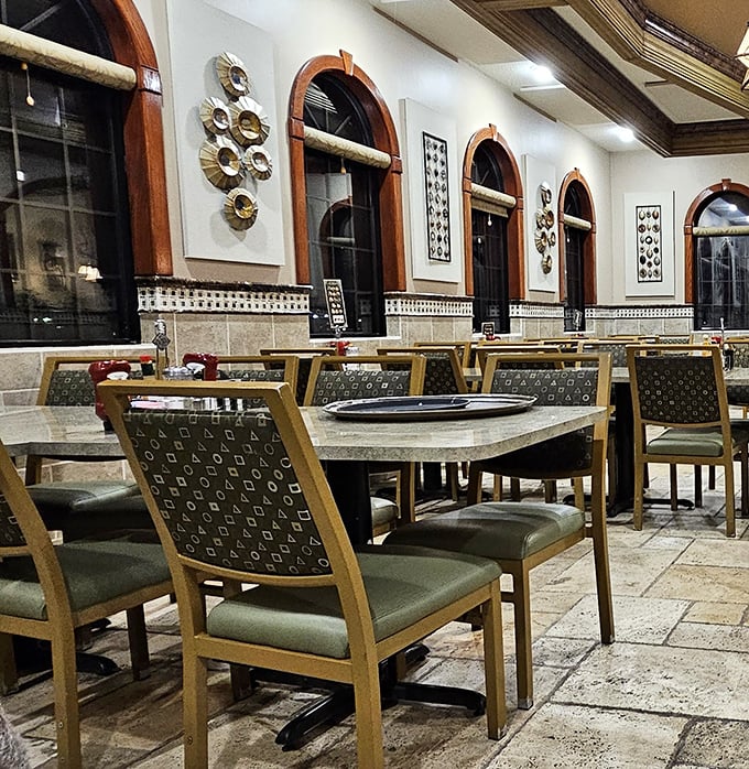 Empty tables that won't stay that way for long. The elegant arches and comfortable seating invite you to settle in for the long haul.