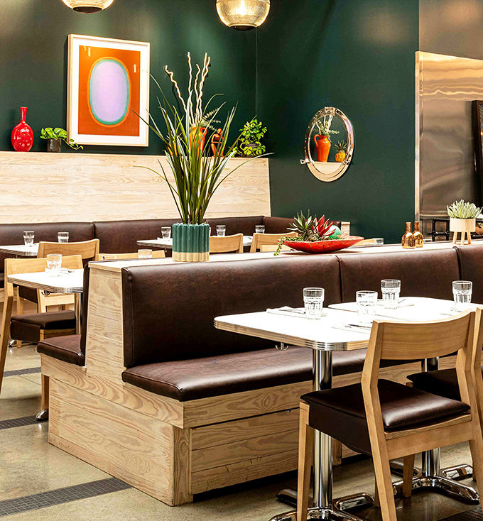 The deep green walls and wooden booths create the perfect backdrop for both first dates and twentieth anniversaries.