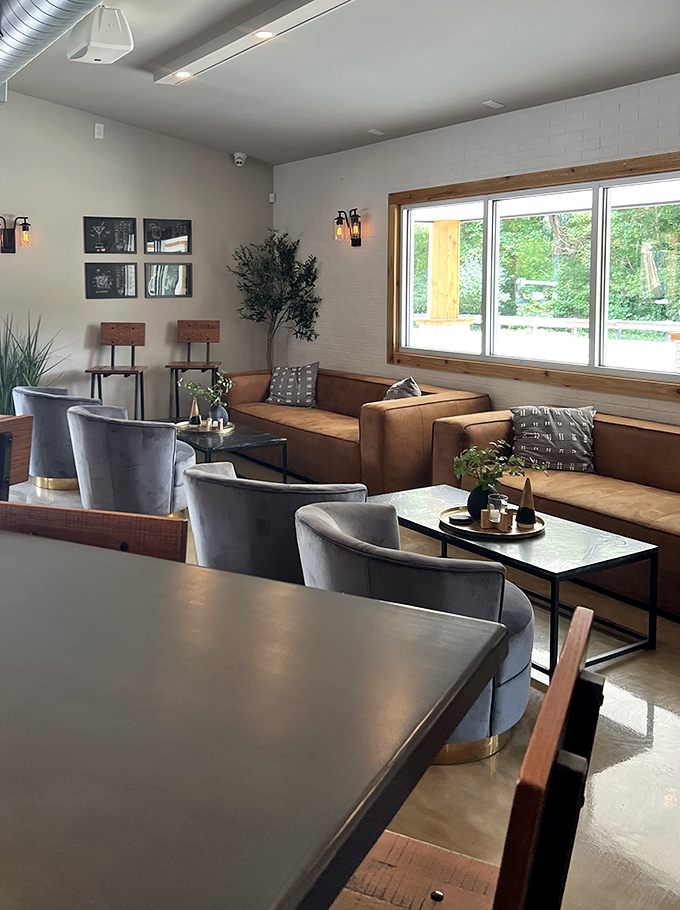 The lounge area invites lingering conversations, where leather meets wood in a space that feels both sophisticated and completely unpretentious.