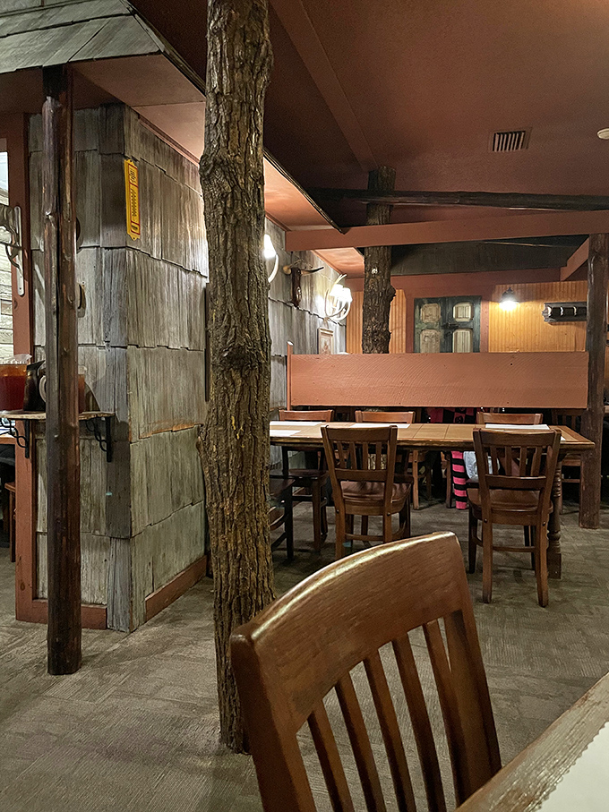 Tree trunks incorporated into the dining room &ndash; because nothing says "authentic rustic" quite like actual nature brought indoors.